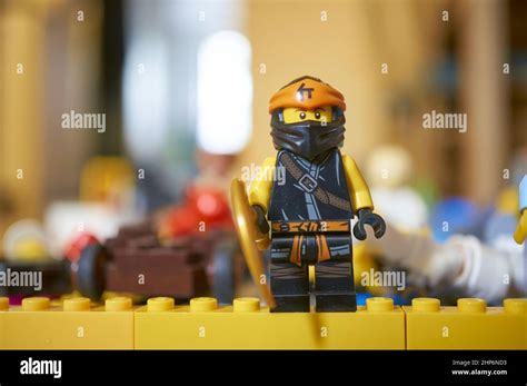 Lego Brand Black Ninjago Ninja Toy Figurine With A Weapon On A Blurred Background Stock Photo