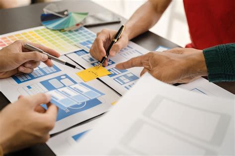 Premium Photo Developer And Ui Designer Brainstorming About Mobile App Interface Wireframe