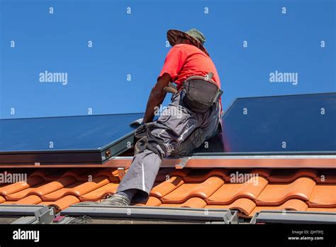 Installation Of A Solar System Craftsmen Attach The Solar Panels Stock Photo Alamy