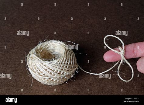 A Finger Tied With Twine But Still Attached To The Original Ball Of Twine Stock Photo Alamy