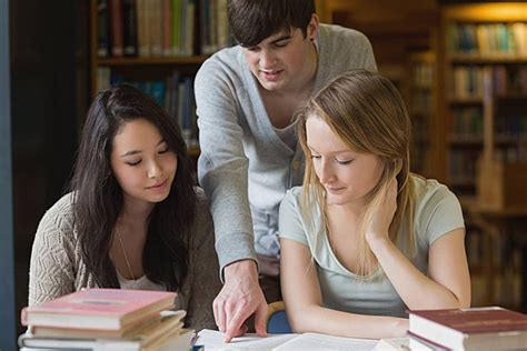 Male Student With Classmates In Computer Class Preparing Team