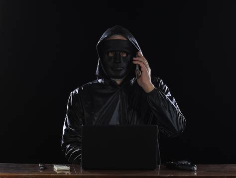 Premium Photo Hooded Masked Hacker With Laptop