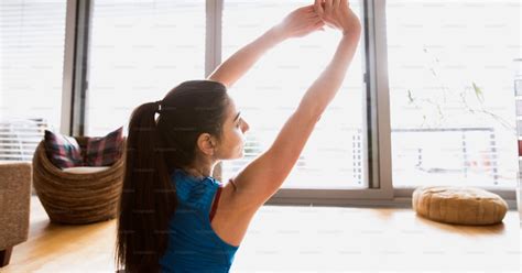 거실에서 집에서 운동하고 요가나 필라테스 운동을 하고 팔을 뻗는 아름다운 젊은 여성 후면도 사진 Unsplash의