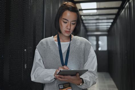 Tablet Server Room And Networking With A Programmer Asian Woman At Work On A Computer Mainframe