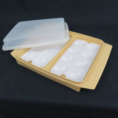 Two Plastic Trays Filled With Food Sitting On Top Of A Black Cloth