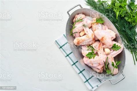 가벼운 슬레이트 돌 또는 콘크리트 배경에서 요리하기위한 향신료와 재료와 흰색 그릇에 원시 닭 날개 복사 공간이 있는 상단 뷰입니다 모의 가금류에 대한 스톡 사진 및 기타