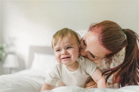 Mother And Baby On White Bed At Home Stock Image Image Of Happiness Care