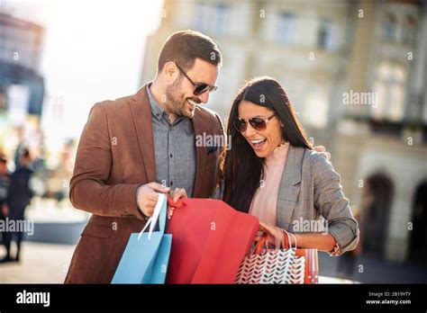 It S Shopping And Fun Time Happy Couple Shopping Together In The City They Are Enjoying Outdoors