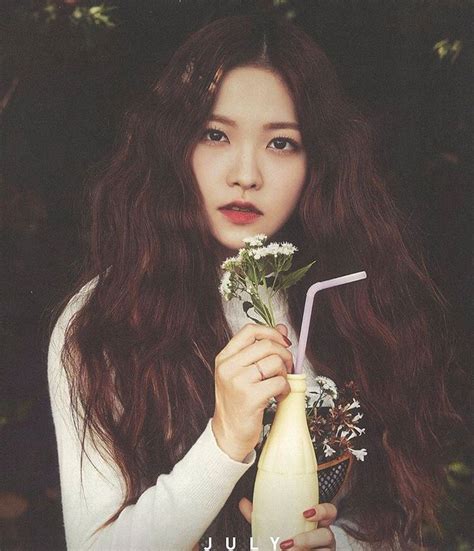 A Woman Holding A Vase With Flowers And A Straw