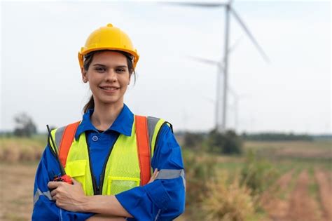 Premium Photo Female Windmill Engineer In Uniform With Helmet Safety Stand And Crossed Arms At