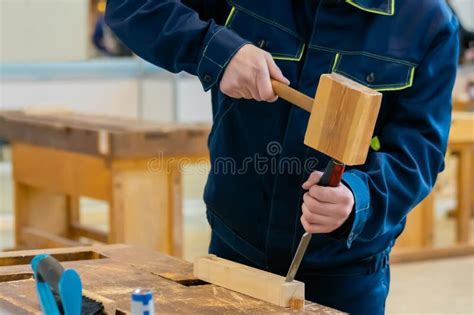 Carpenter Using Chisel And Hammer To Carve Wood Close Up Stock Image