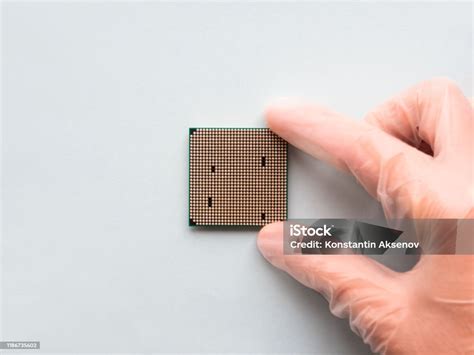 hand in rubber glove with central computer processor cpu on blue