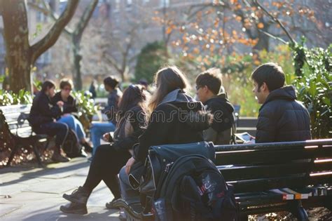 A Group Of Students Chat And Relax On Benches In A Park Between Classes Groups Of Friends A Group Of Students Chat And Relax On Benches In A Park Between Classes Groups Of Friends