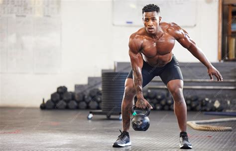 Premium Photo Black Man Fitness And Weightlifting With Kettlebell For