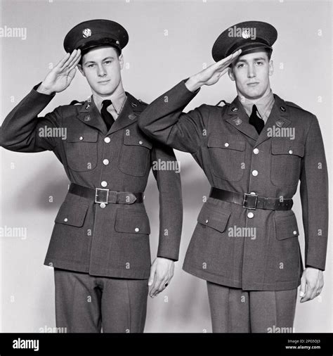 1940s Two Men In Army Uniforms Looking At Camera Saluting Just Enlisted
