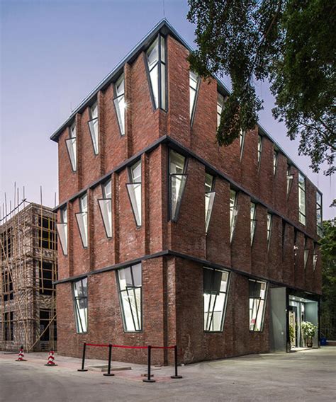 Red Brick Facade With Angular Windows Enfolds Multi Use Building In China