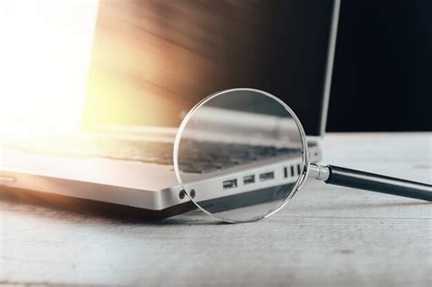 Premium Photo Laptop Computer With Magnifying Glass