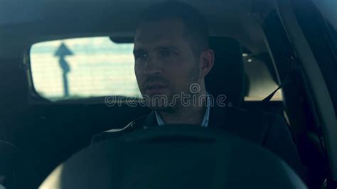 Handsome Young Man Sitting In The Car And Driving Caucasian Man In