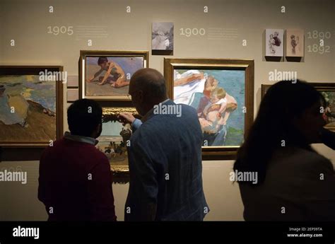 Visitors Look At Artworks During The Exhibition Tierra Adentro At