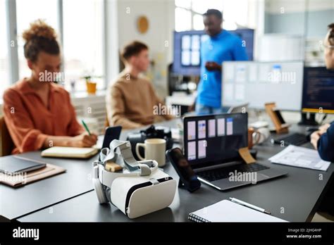 Horizontal Image Of Vr Glasses Lying On Table While Programmers Testing