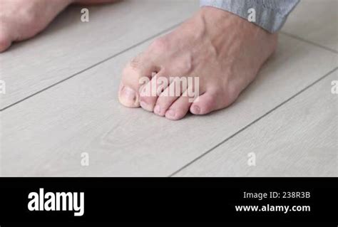 Demonstration Of Foot Massage Technique Barefoot On Wooden Floor