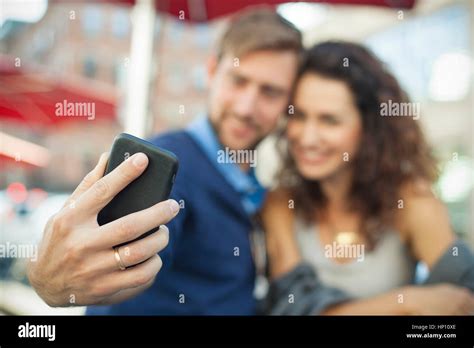 Man Using Smartphone To Photgraph Himself With His Wife Stock Photo Alamy