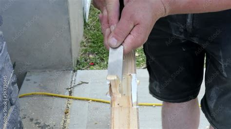 Wooden door installation of a hinge working with chisel prepared for mounting on a hinges vídeo