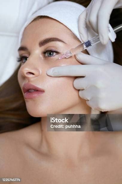 얼굴 치료 스킨케어를 위한 미용 사출 절차 미용 살롱에서 젊은 여자입니다 주사기와 미용사 손의 클로즈업 20 29세에 대한 스톡
