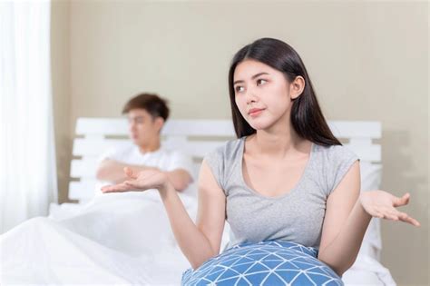 Premium Photo Unhappy Sad Couple Sitting In Bed Away From Each Other