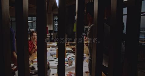 Diverse Business Team Collaborating In Modern Office Using Sticky Notes For Project Planning