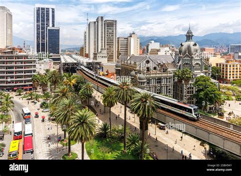 Medellin Skyline With Metro De Medellín Train At Plaza Botero Square In