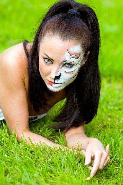 Premium Photo Woman With Face Art On Grass