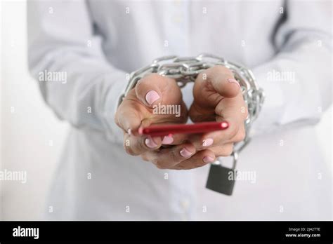 Woman Is Holding Smartphone With Her Hands Tied With Chain Stock Photo Alamy