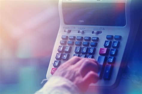 Premium Photo Person Typing On A Calculator