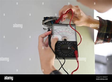 Cropped Shot Of Electrician Using A Multimeter To Test The Electrical Installation And Power