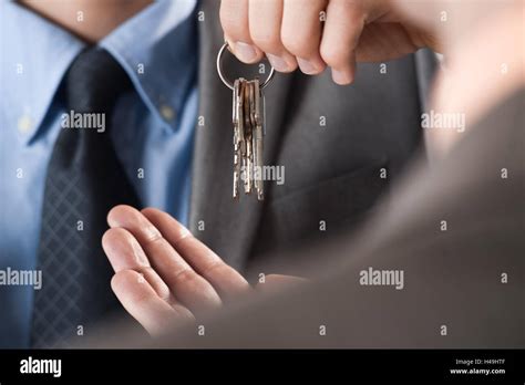 A Man Places To Another Man Key In The Hand Close Up Detail Stock Photo Alamy