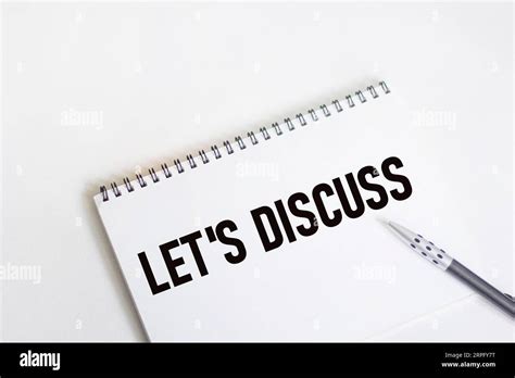 Let S Discuss Text On Notepad Isolated On White Background Stock Photo