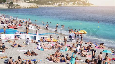 Crowded Public Beach At Seashore Many People Sun Tanning Splashing In Water Stock Image