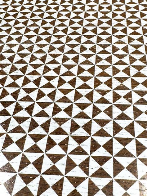 Geometric Pattern Of Brown And White Triangular Motifs On Surface Stock