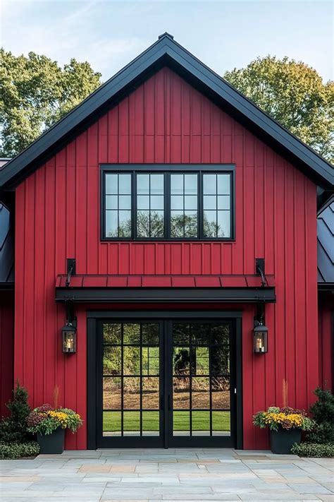 Modern Barn Style Red House Facade With Black Barn Doors In A Green