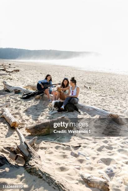 Happy Woman Sitting On Beach Log Photos And Premium High Res Pictures