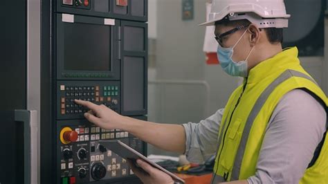 worker man operating automated programming cnc milling control machine