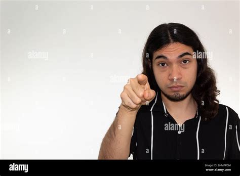 Hispanic Man Pointing With His Hands To A Copy Space On A White