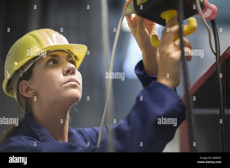Female Engineer Checking Valves And Cables In Factory Stock Photo Alamy