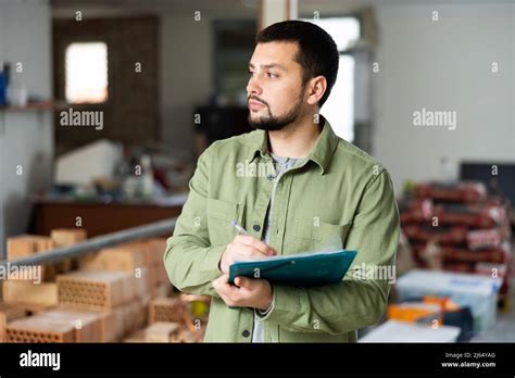 Architect Making Notes On Indoor Construction Site Stock Photo Alamy