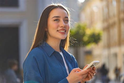 Young Woman Using Smartphone Typing Text Messages Looking For A Way On