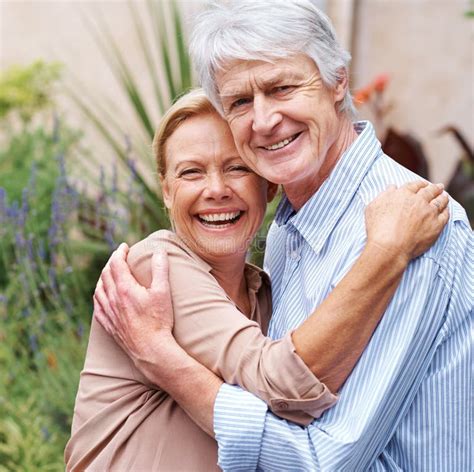 Portrait Hug Or Elderly Couple In Park To Smile Embrace Or Enjoy Bonding Together In