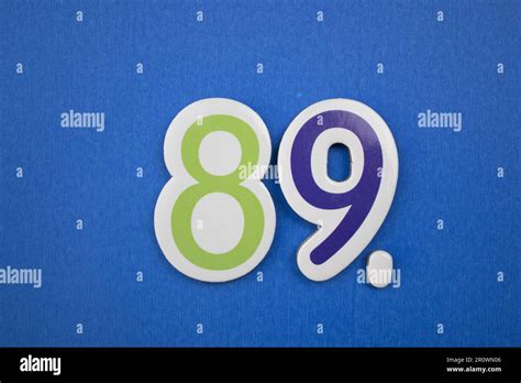 The Number 89 Placed On A Blue Background Photographed From Above In Dark Blue And Green