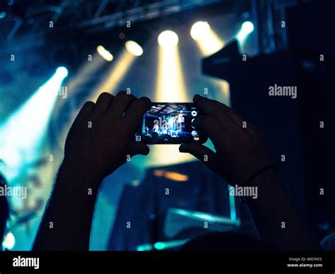Concert Crowd Clapping In Front Of A Bright Stage Stock Photo Alamy