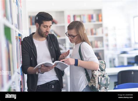 Happy Babes Couple In Babe Library Have Discussion About Book Stock Photo Alamy